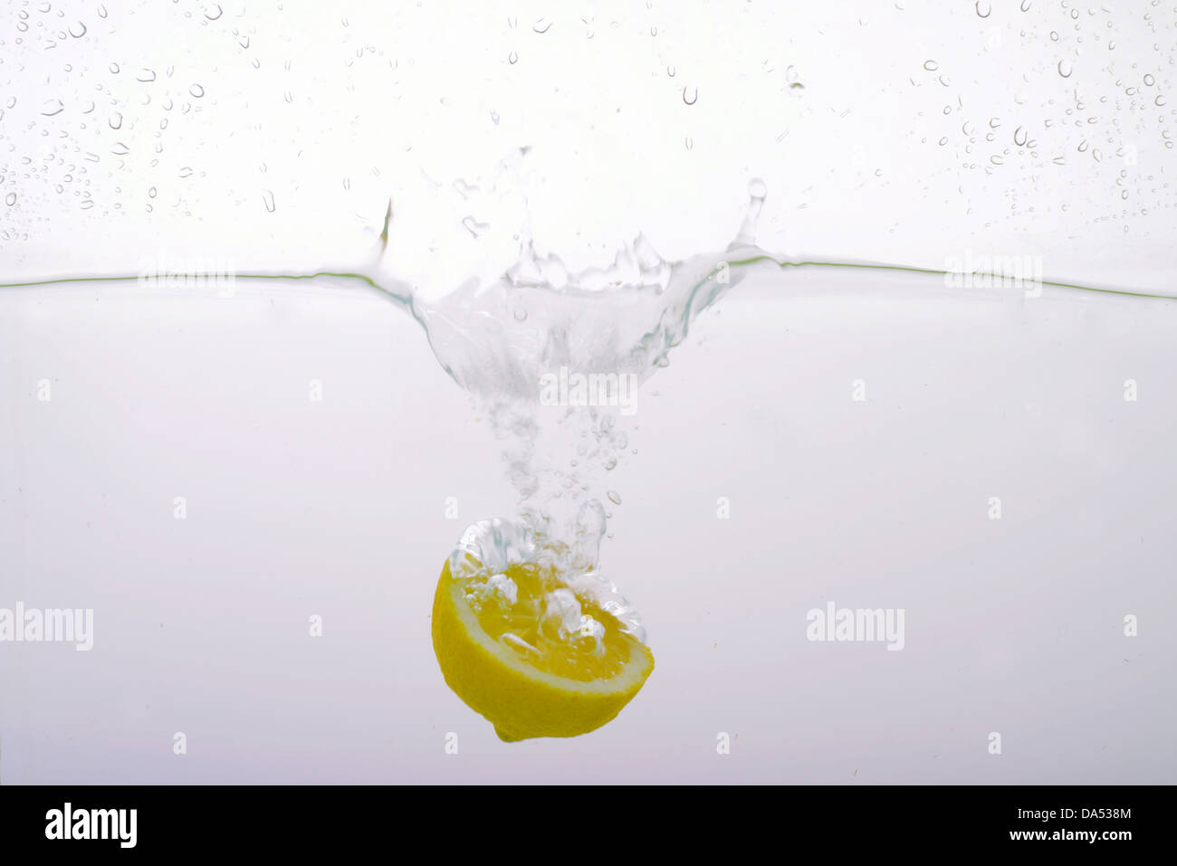 Lemon splashed into water Stock Photo - Alamy