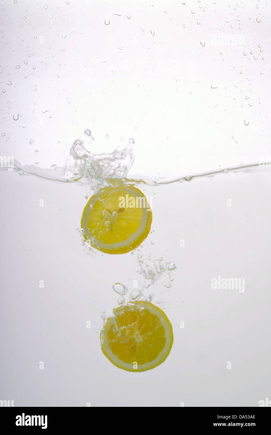 Lemon splashed into water Stock Photo - Alamy