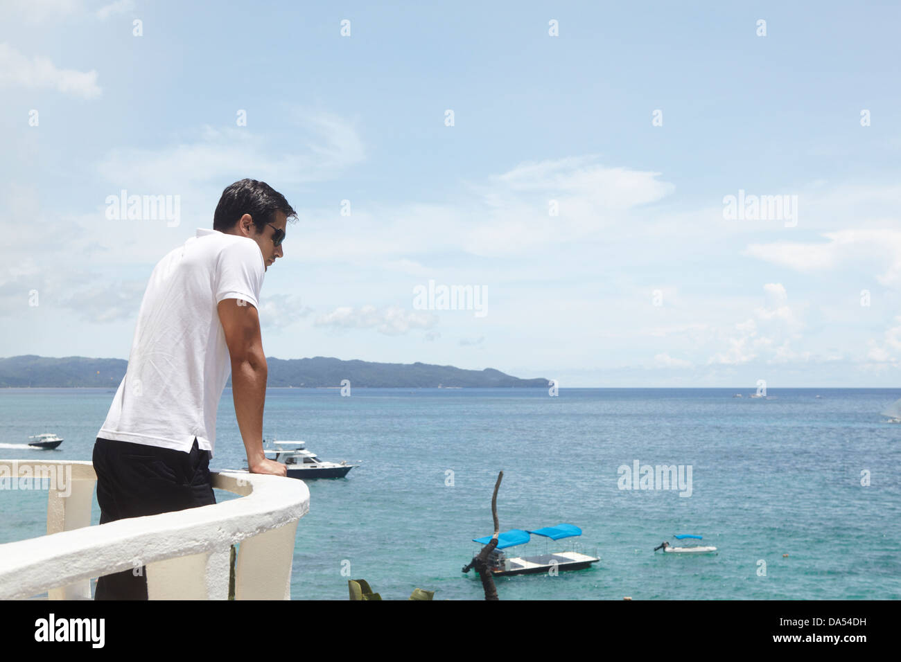 A young man standing on a balcony Stock Photo - Alamy