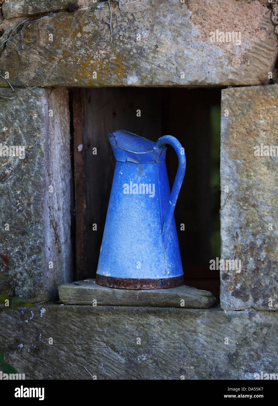 Pretty French metal blue water jug in stone alcove. A very French image ...