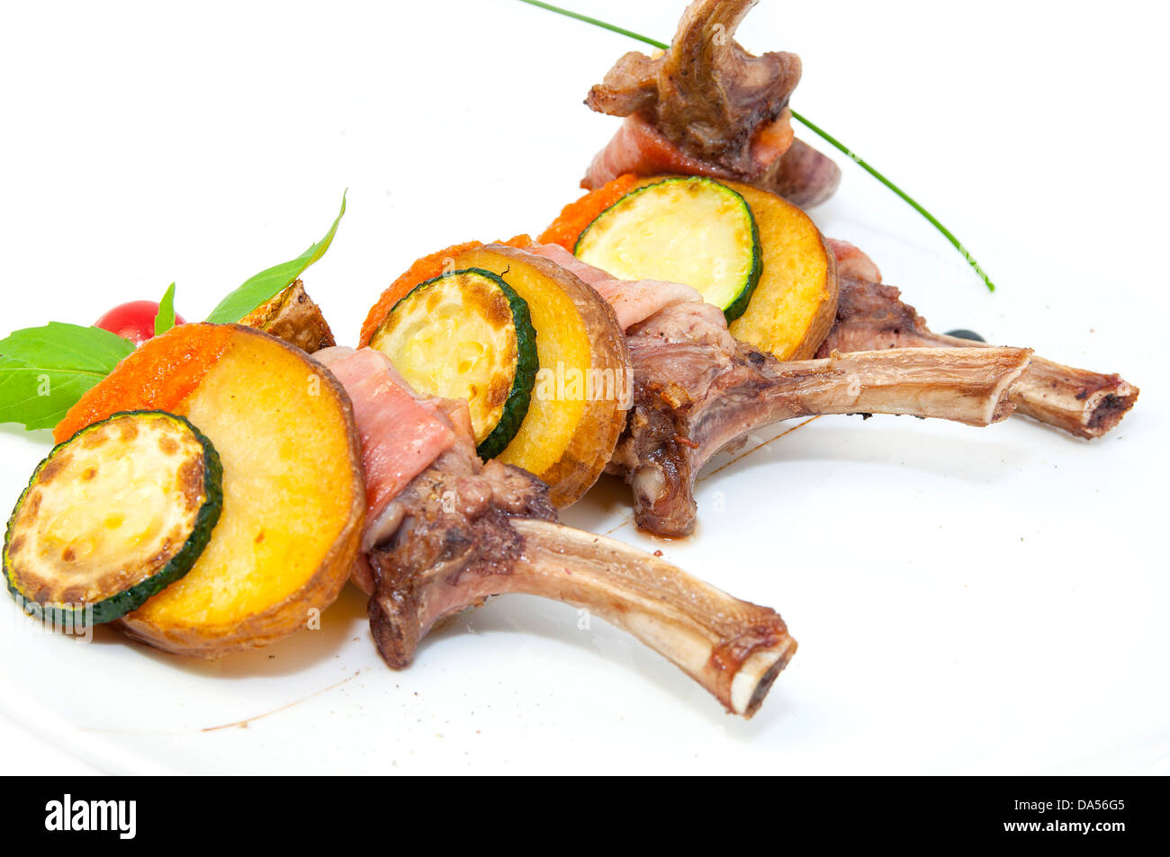 roasted veal ribs with vegetables on a white plate in a restaurant ...