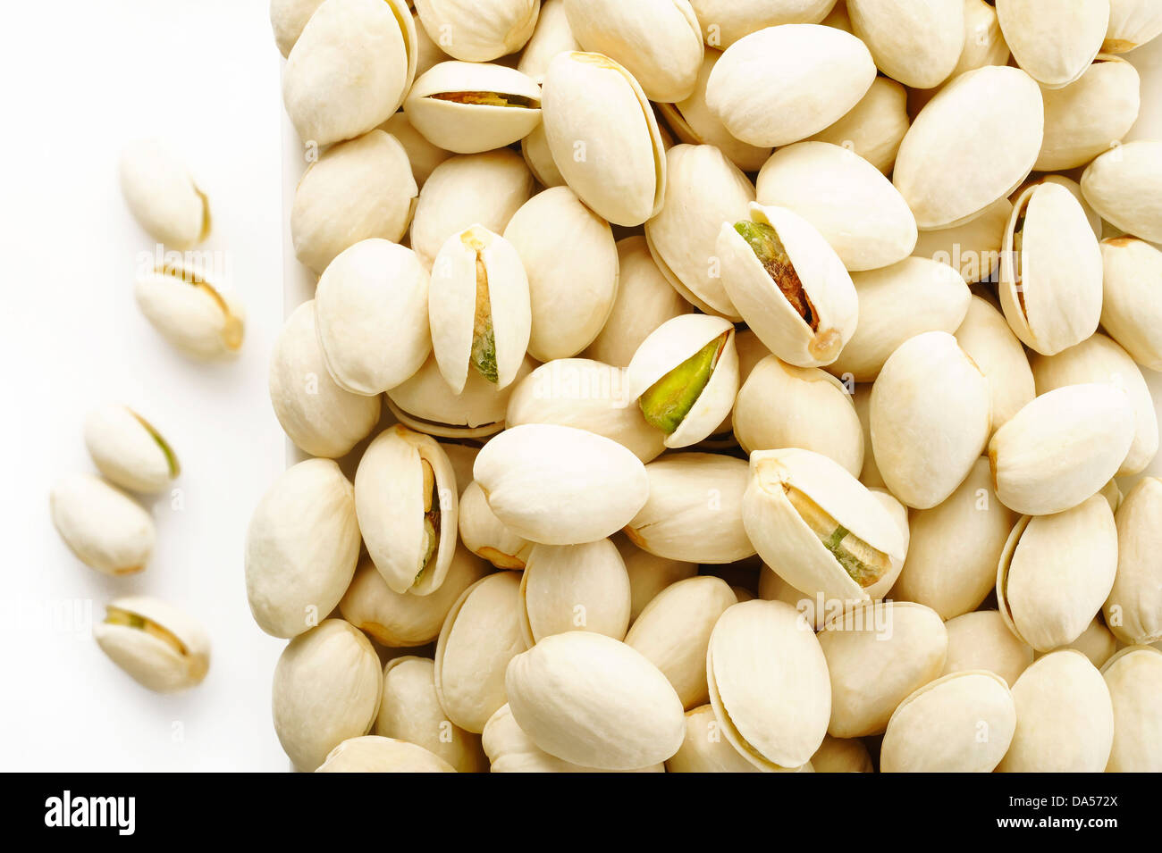 salted pistachio nuts on white background Stock Photo - Alamy
