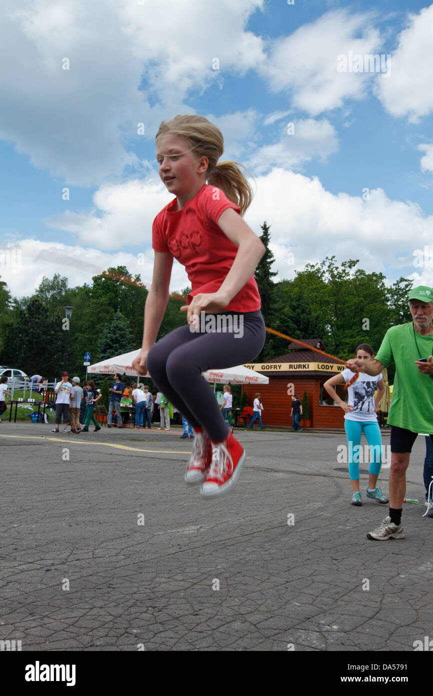 Girl jumping over a skipping rope Stock Photo - Alamy