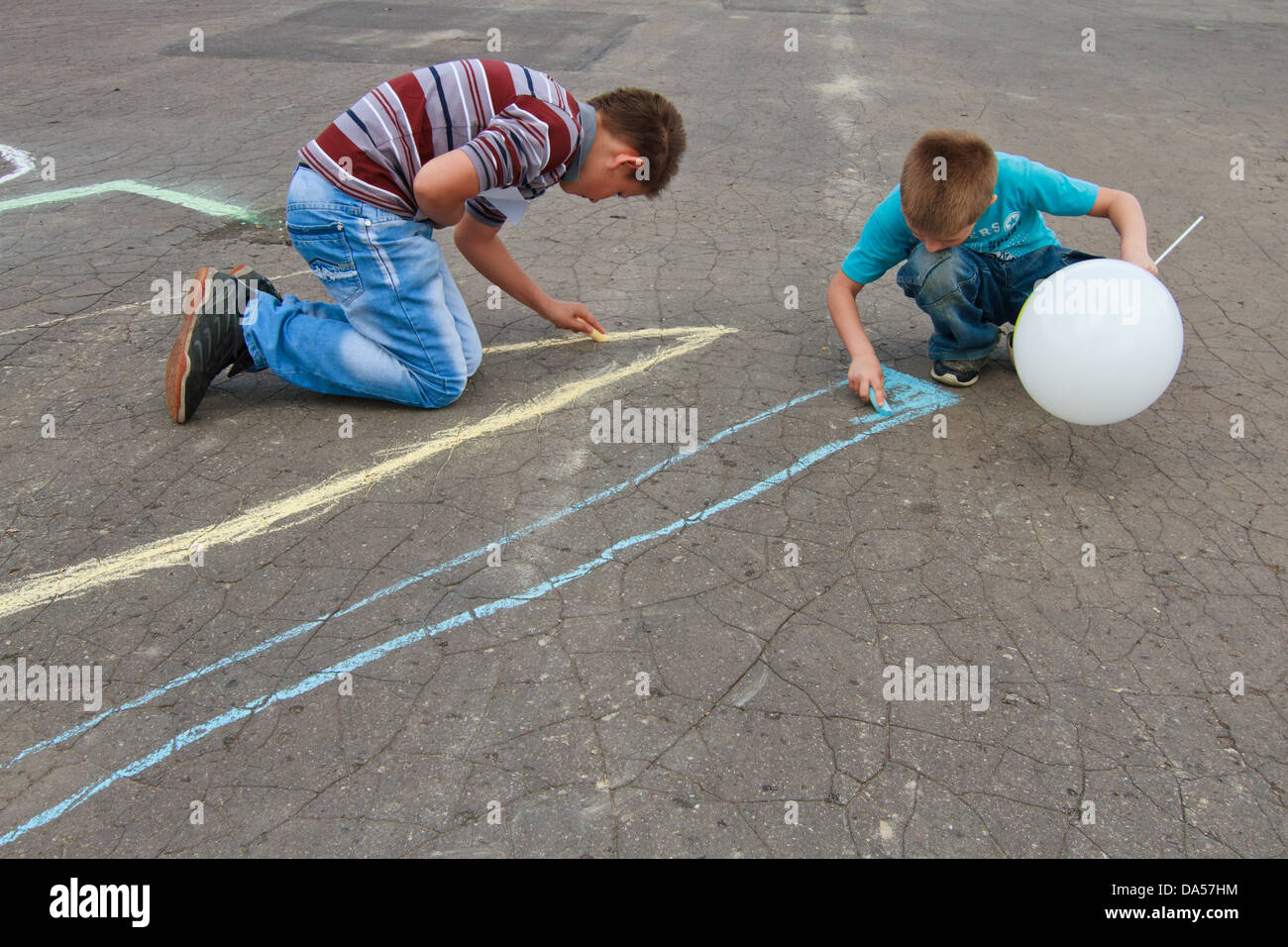 Drawing with crayons on asphalt Stock Photo - Alamy
