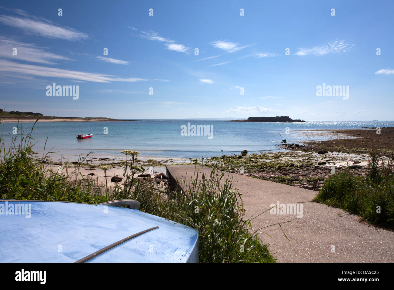 Upturned blue boat Longis Bay Alderney Channel Islands Stock Photo - Alamy