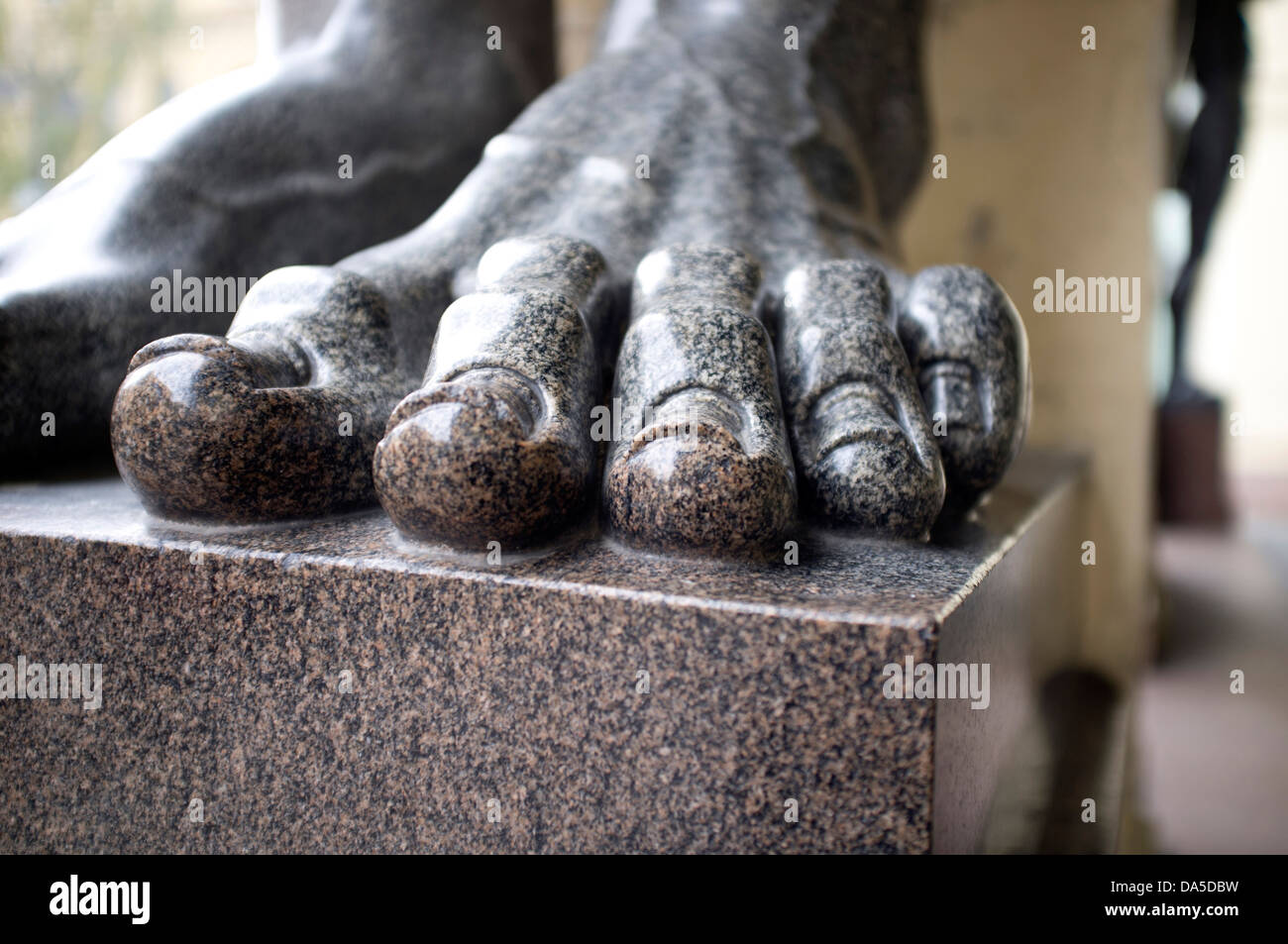 Close up of foot of a large sculpture of a Roman figure holding up a ...