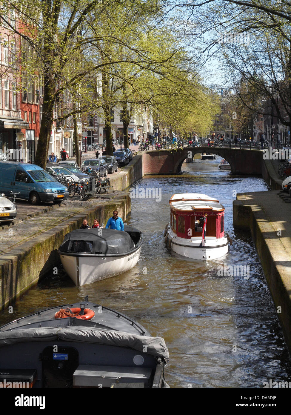 Canals in Amsterdam - Locals enjoy the spring sun on typical canal ...