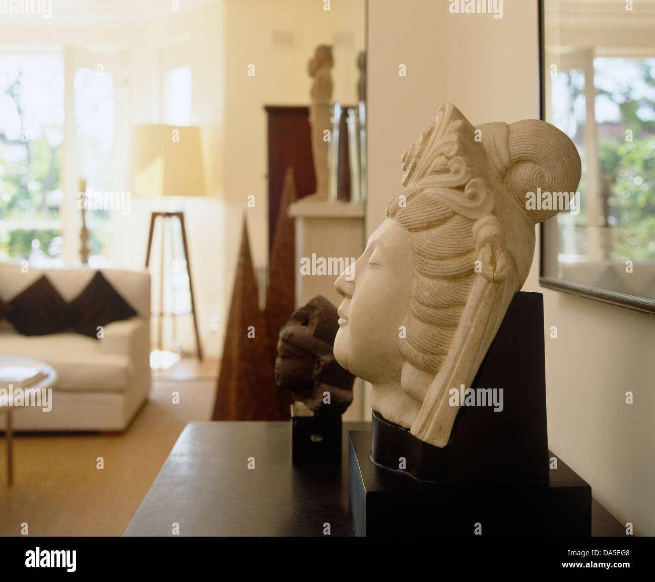 Close-up of sculpture of female head on dark wood side table Stock ...