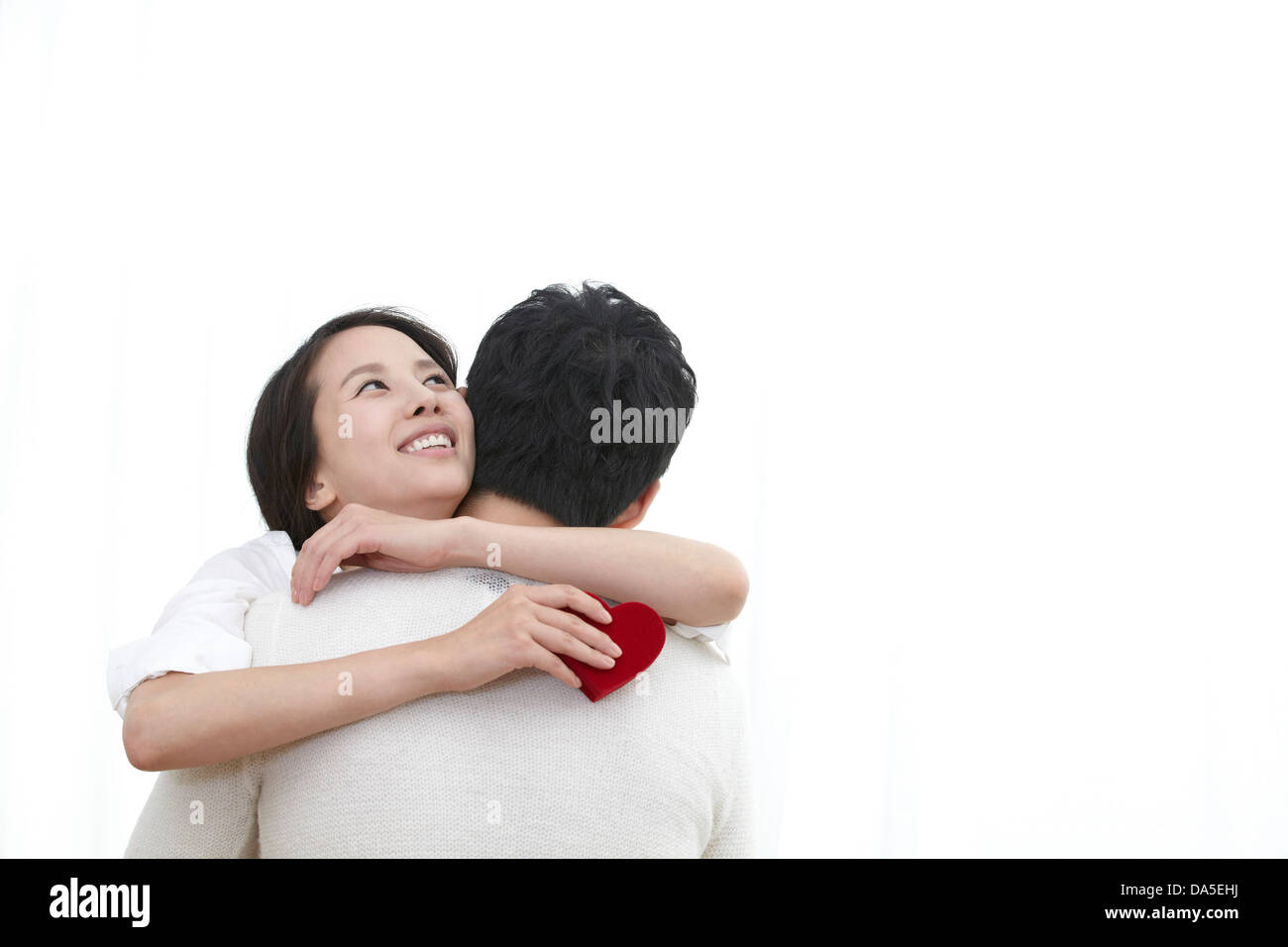 A young couple embracing Stock Photo - Alamy