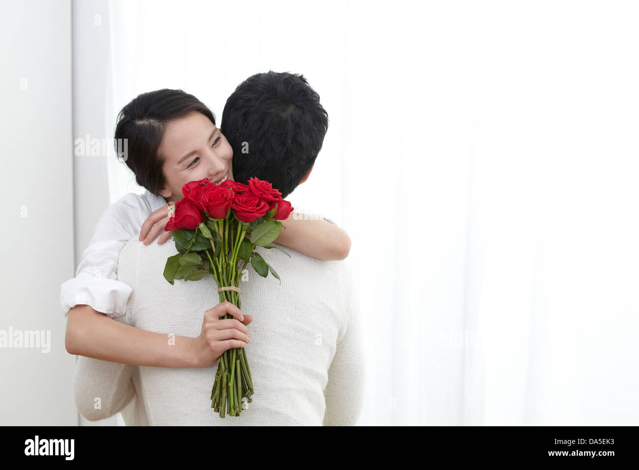 A young couple embracing Stock Photo - Alamy