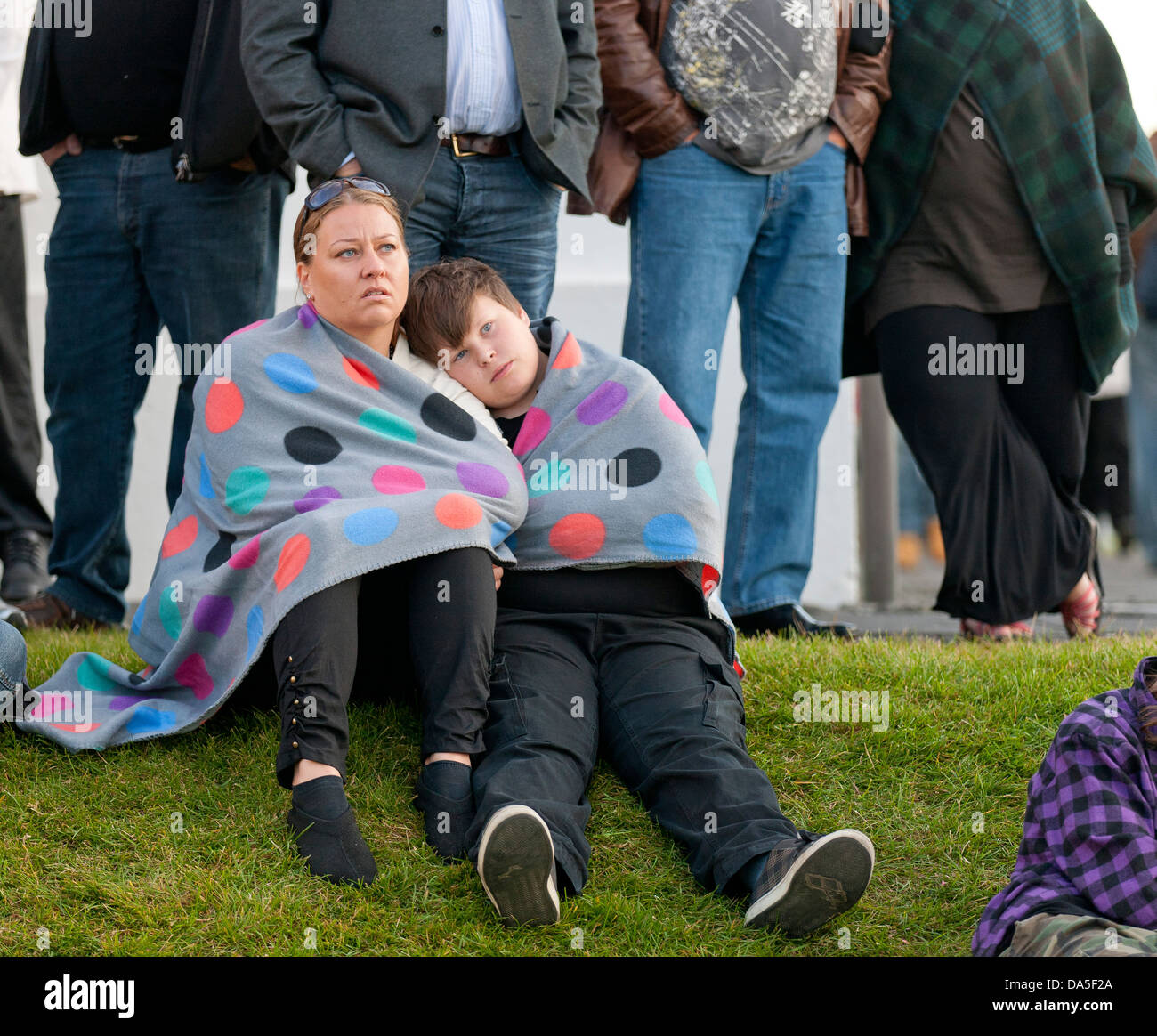 Mother and son sharing a blanket while watching a concert in Reykjavik ...