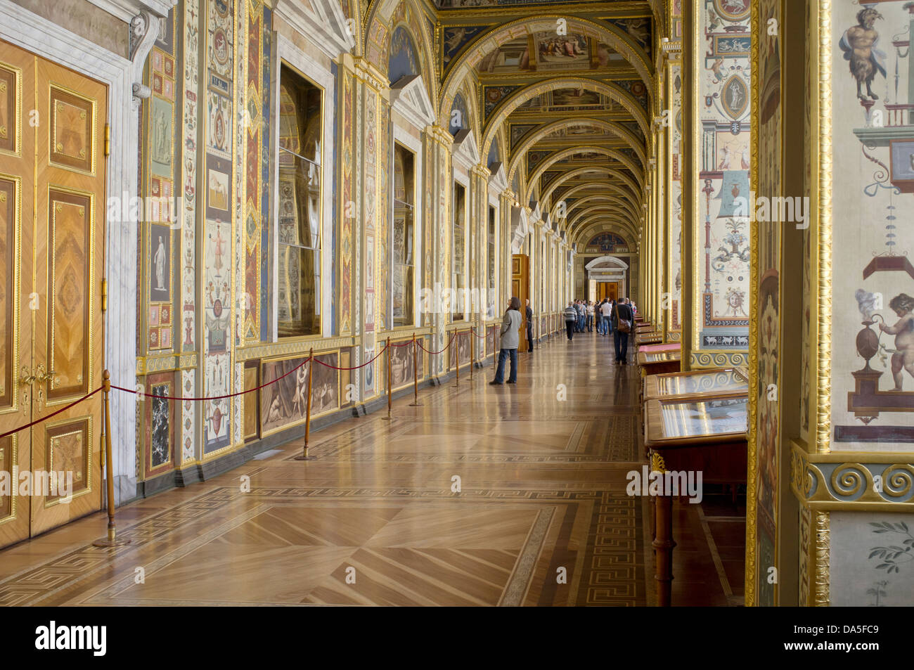 Long corridor ornately decorated in the State Hermitage museum, a ...