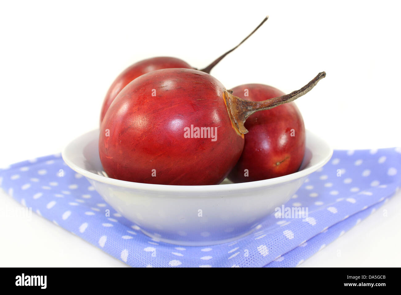 three red tamarillo in front of white background Stock Photo - Alamy