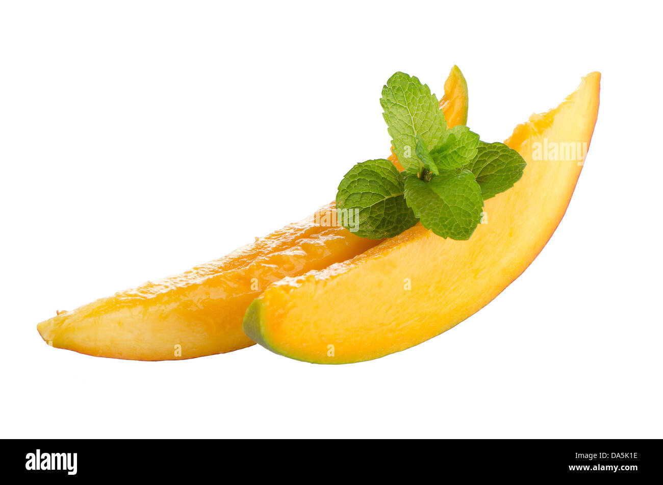 Mango fruit slices on white reflective background Stock Photo - Alamy