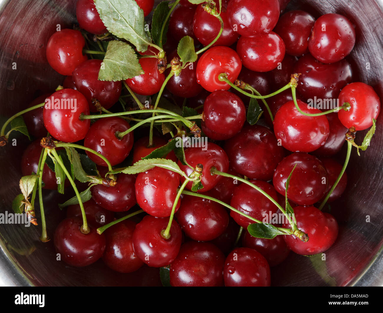 ripe cherries with stem and leaves, background Stock Photo - Alamy