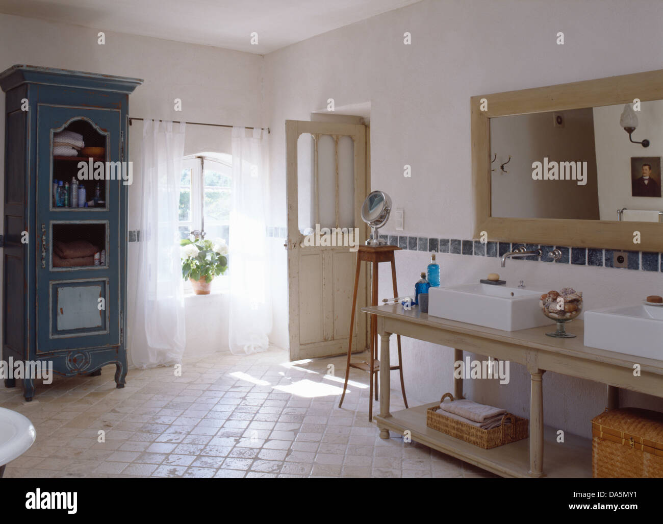 Wood framed mirror above rectangular double wash basins in simple wood ...