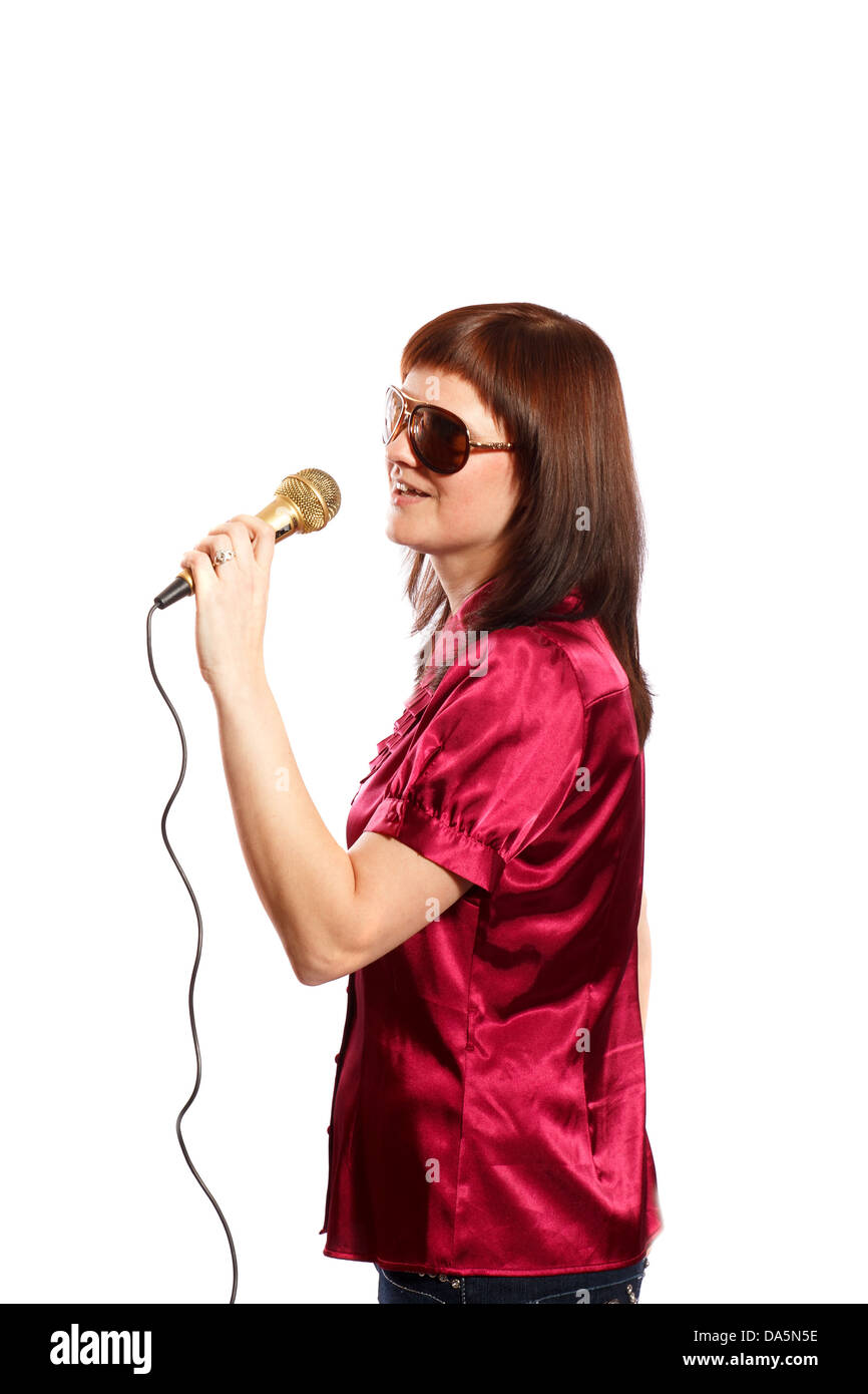 Woman with big sunglasses singing into a microphone Stock Photo - Alamy