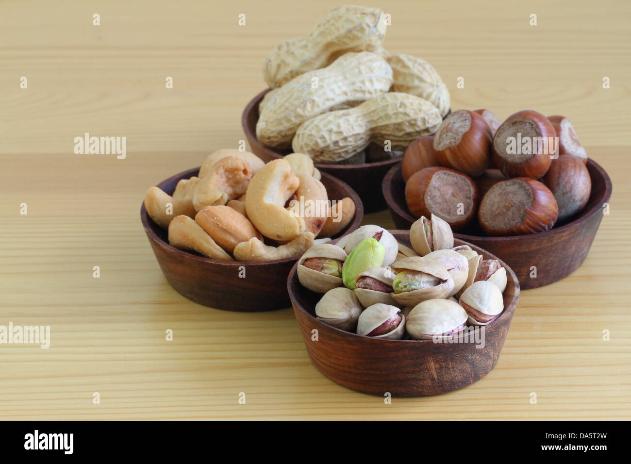 Mixed nuts with and without shell in wooden bowls with copy space Stock ...