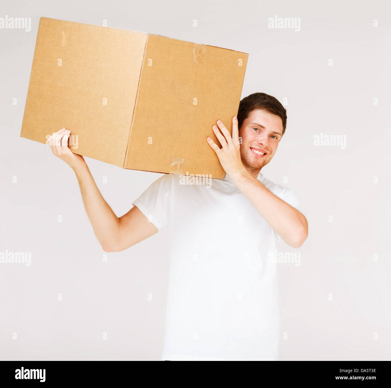 smiling man carrying carton box Stock Photo - Alamy