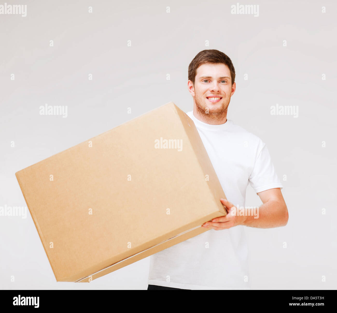 smiling man carrying carton box Stock Photo - Alamy