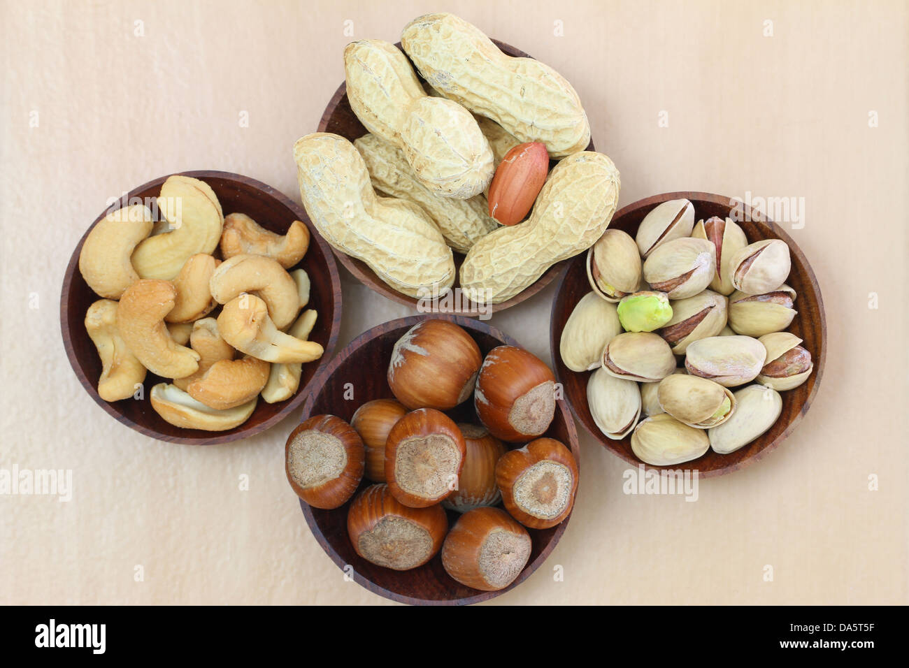 Mixed nuts with and without shell in wooden bowls Stock Photo - Alamy