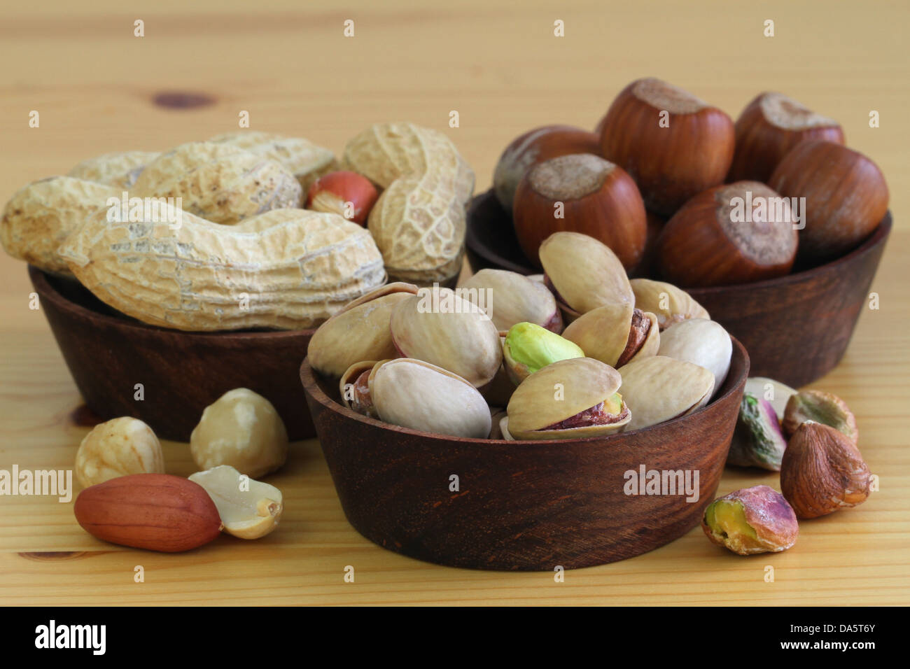 Mixed nuts with and without shell in wooden bowls Stock Photo - Alamy