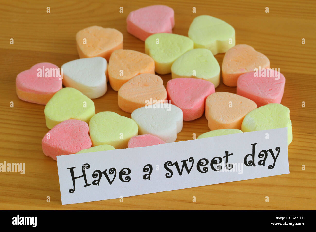Have a sweet day note with colorful sugar hearts Stock Photo - Alamy