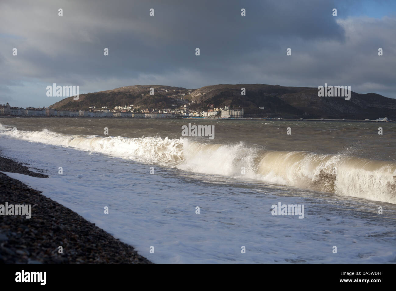 Gently rolling waves at Llandudno beach in front of The Great Orme ...
