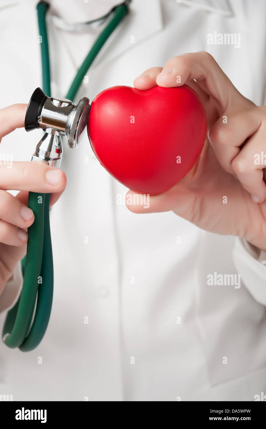 A doctor with stethoscope examining heart hi-res stock photography and ...