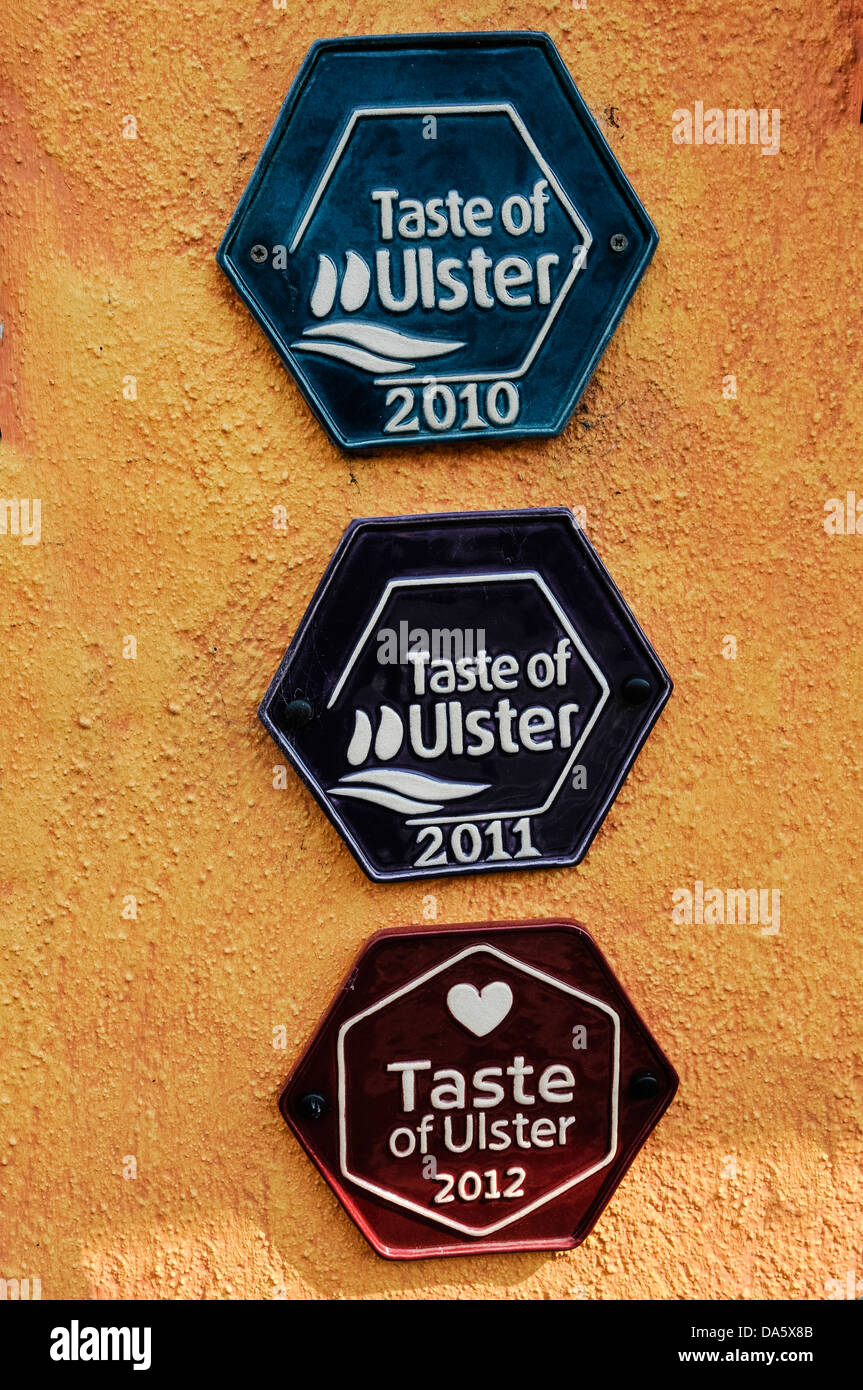 Three "Taste of Ulster" awards on the wall of a restaurant Stock Photo ...