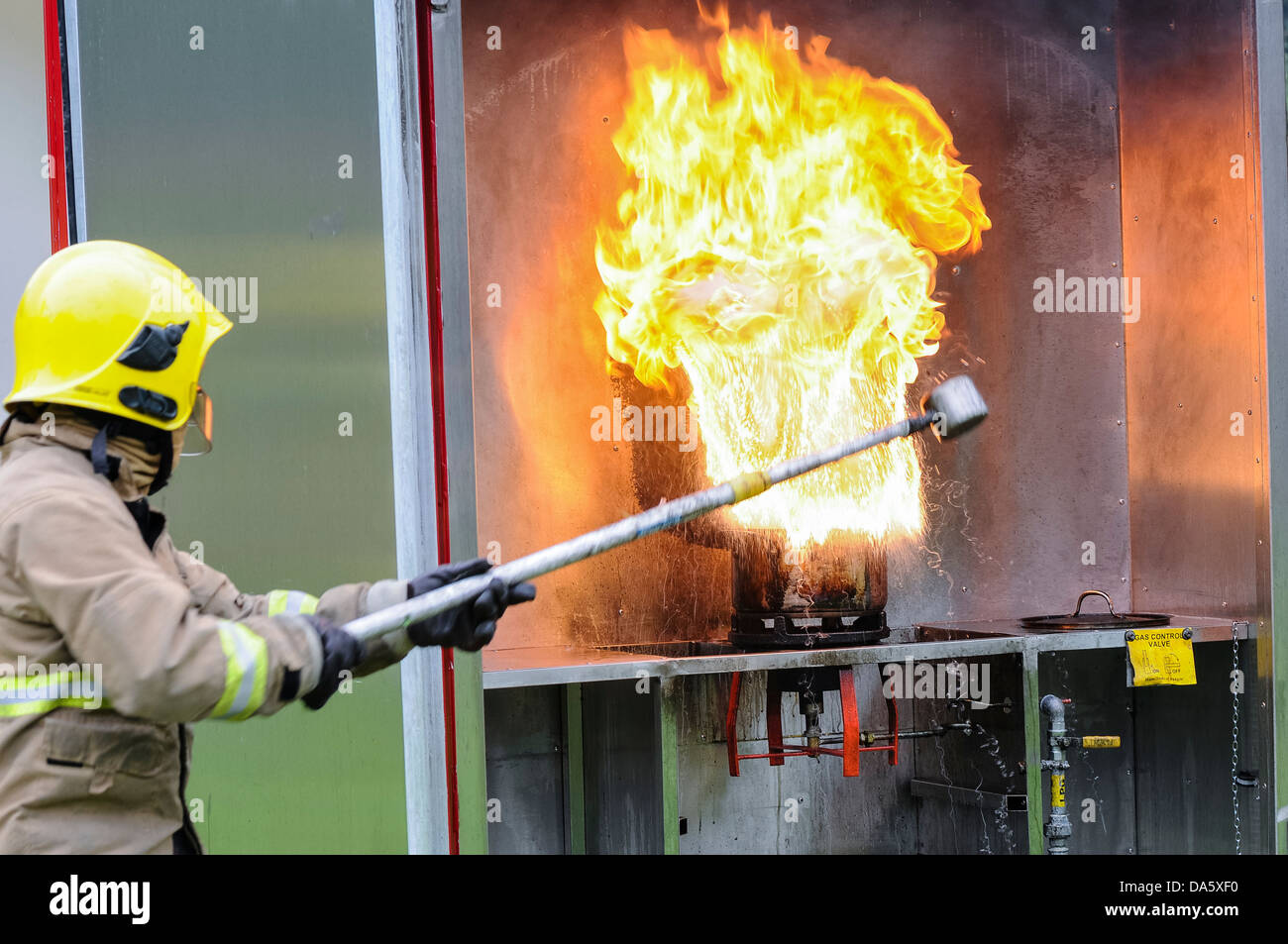 A fireman demonstrates the result of pouring a small amount of water ...
