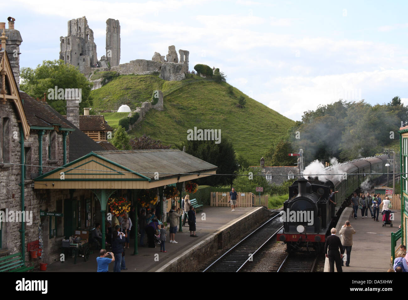 Corfe Castle railway station with castle in background and steam train ...