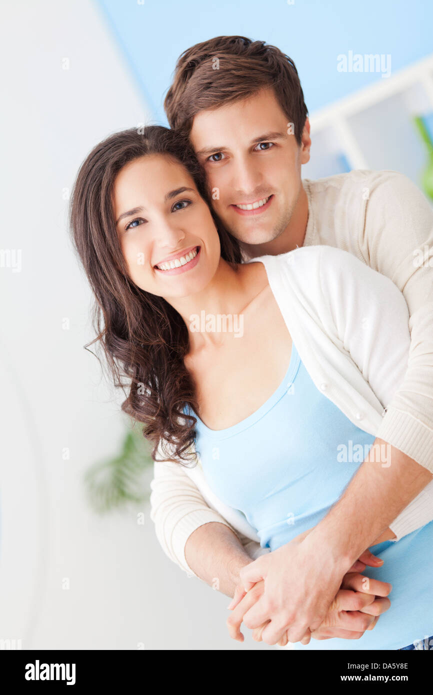 Happy young couple in their modern living room Stock Photo - Alamy