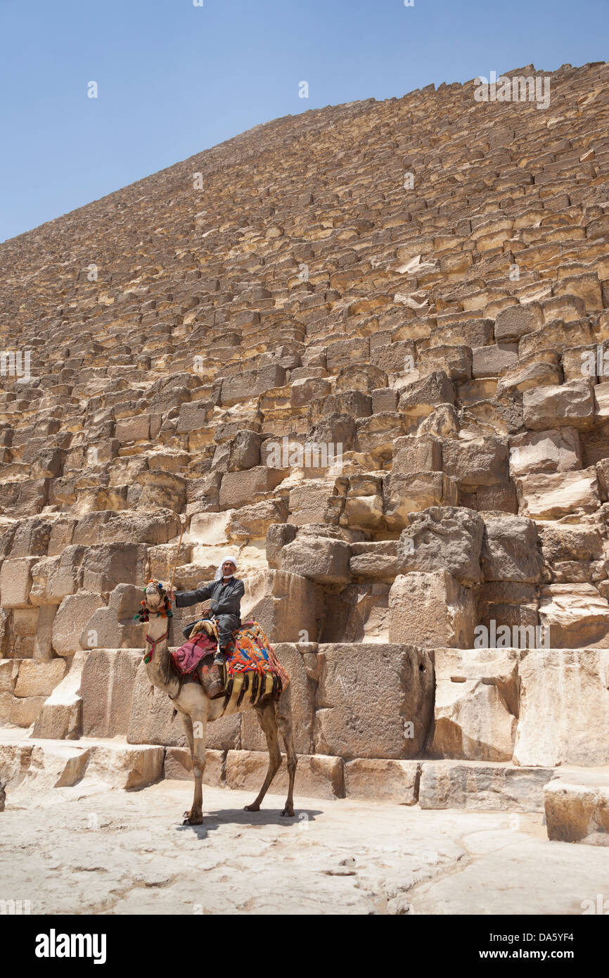 Man and camel beside Great Pyramid of Giza, also known as Pyramid of ...