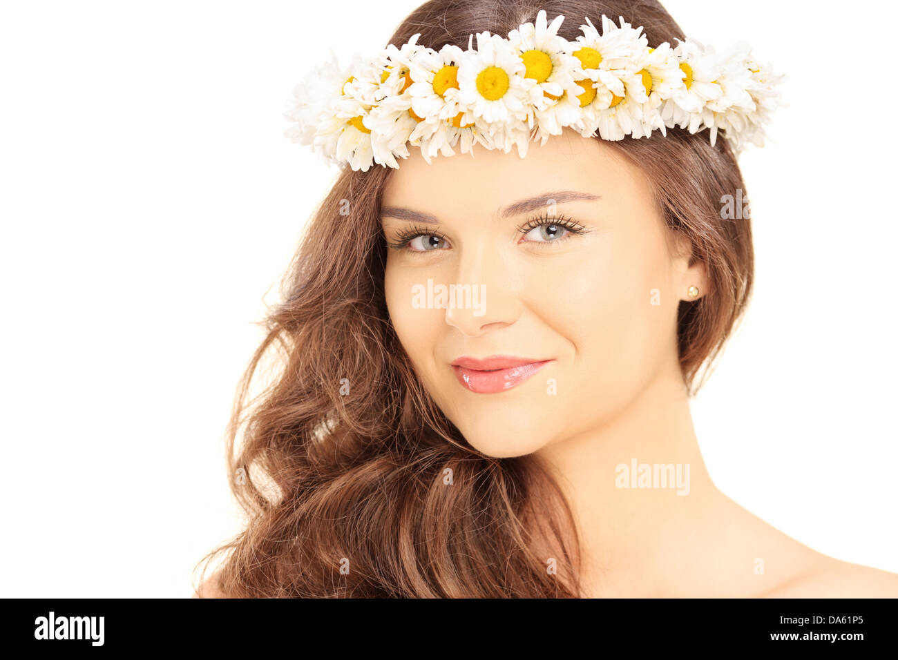 Beautiful young female with a daisy hair wreath looking at camera ...