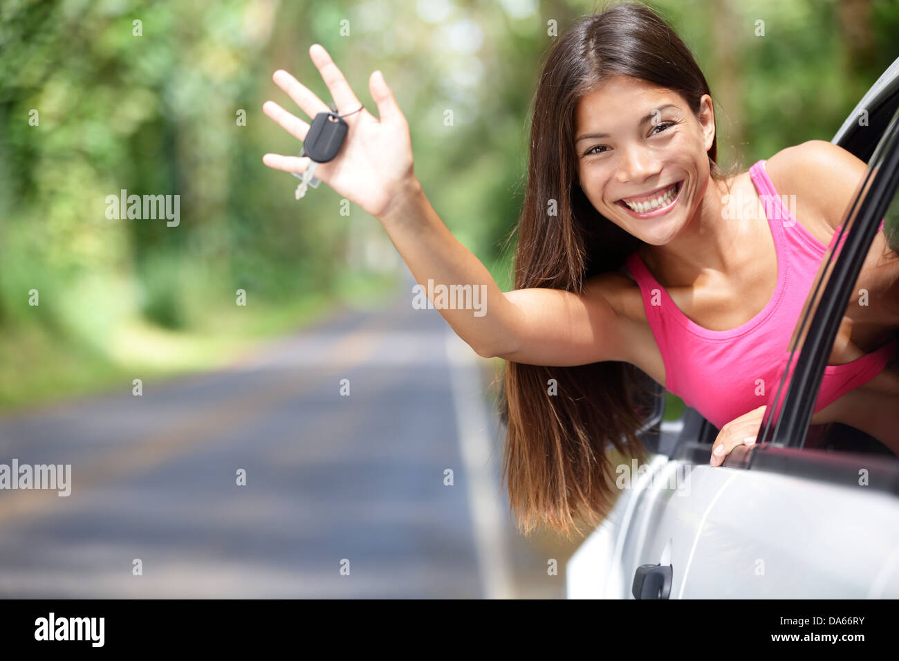 Car - woman showing new car keys smiling happy on road trip after ...