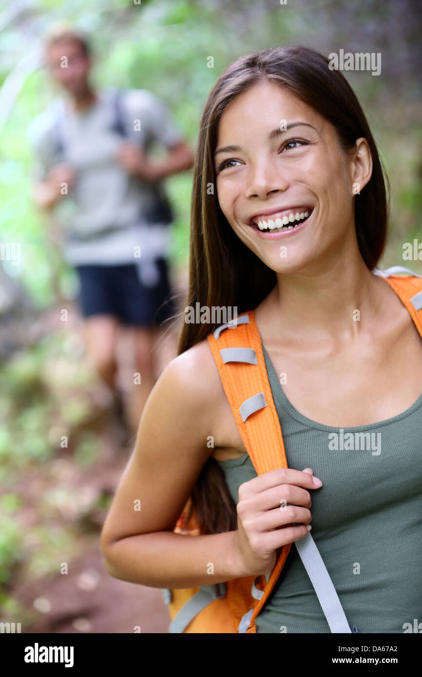 Hiking woman. Portrait of happy female hiker smiling looking away ...