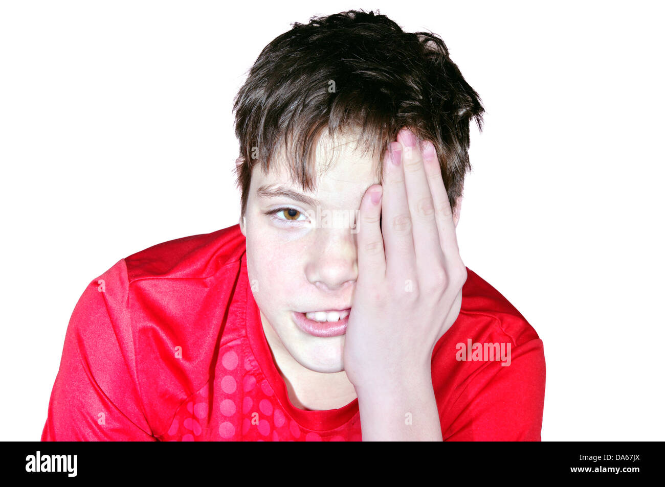 Portrait of happy cute little boy closed one eye with his hand, studio ...