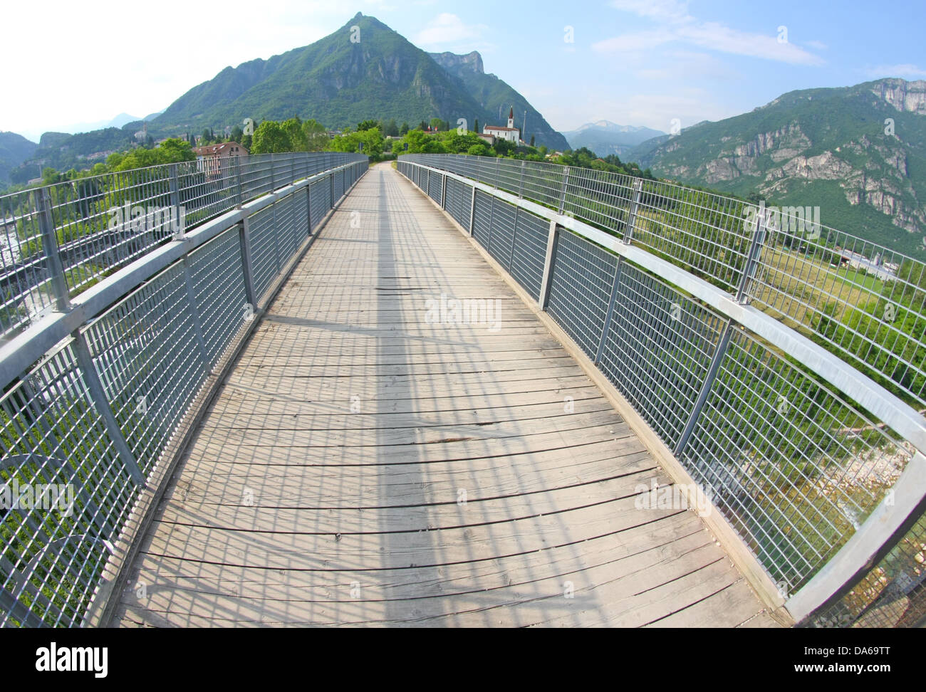 long bridge with a wooden walkway and handrail made of galvanized steel ...