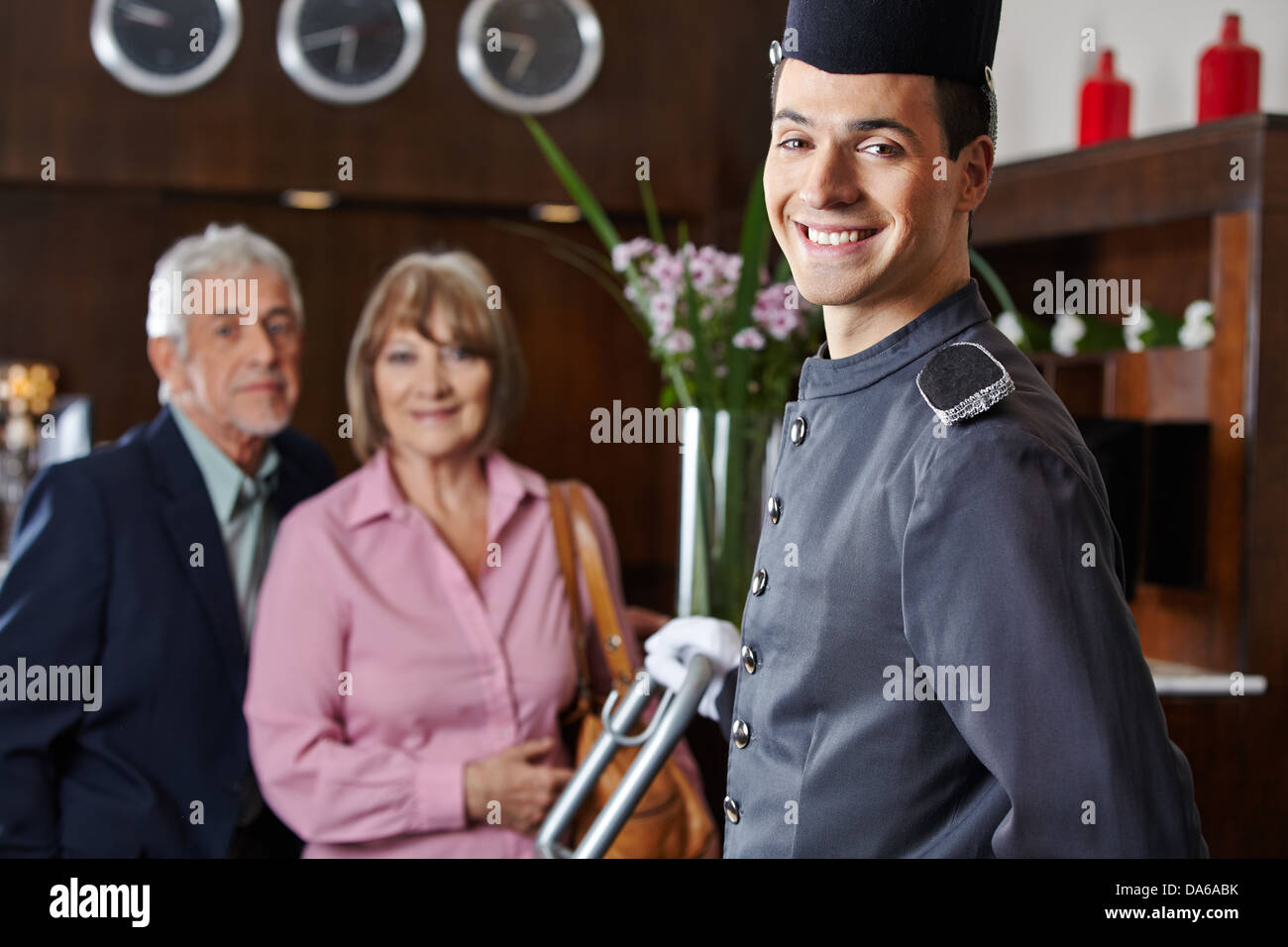 Smiling concierge with senior couple in a hotel Stock Photo - Alamy