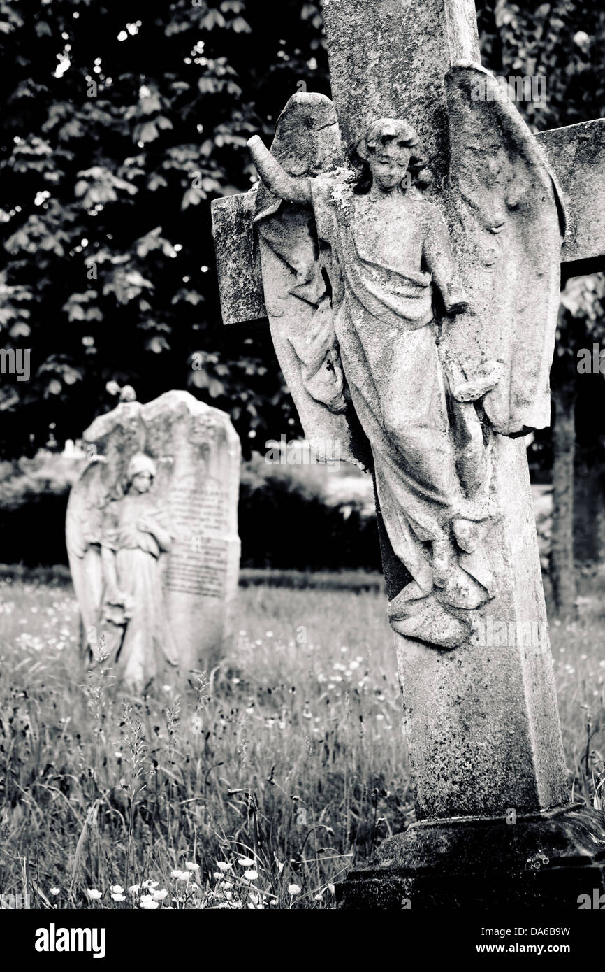 Angel on cross with damaged hand Stock Photo - Alamy