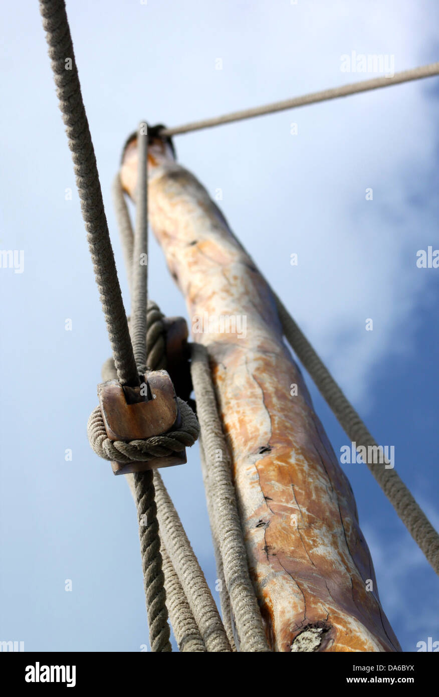 A closeup of a traditional dhow sail and rope rigging on blue sky cloud ...