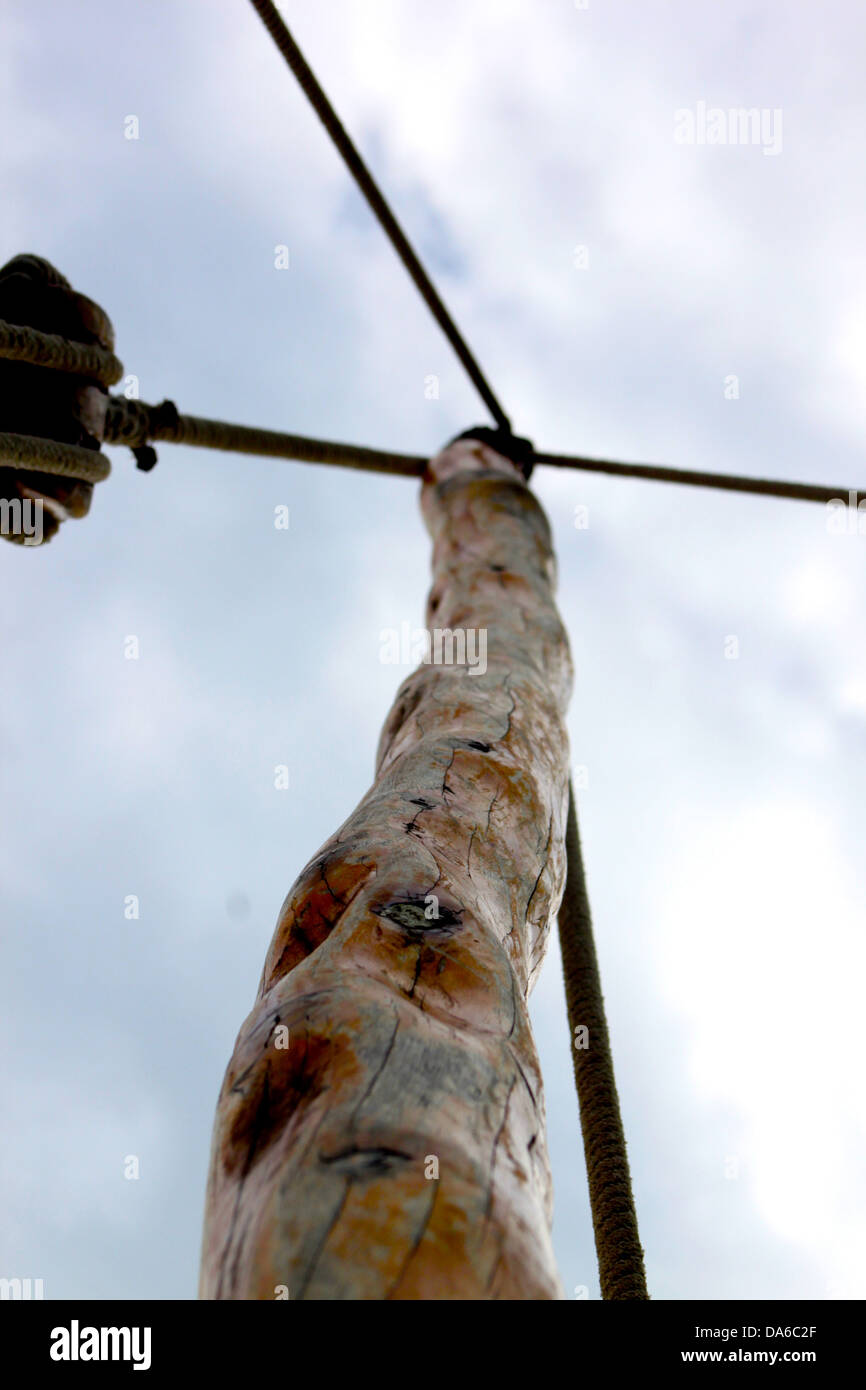 A closeup of a traditional dhow sail and rope rigging on blue sky cloud ...