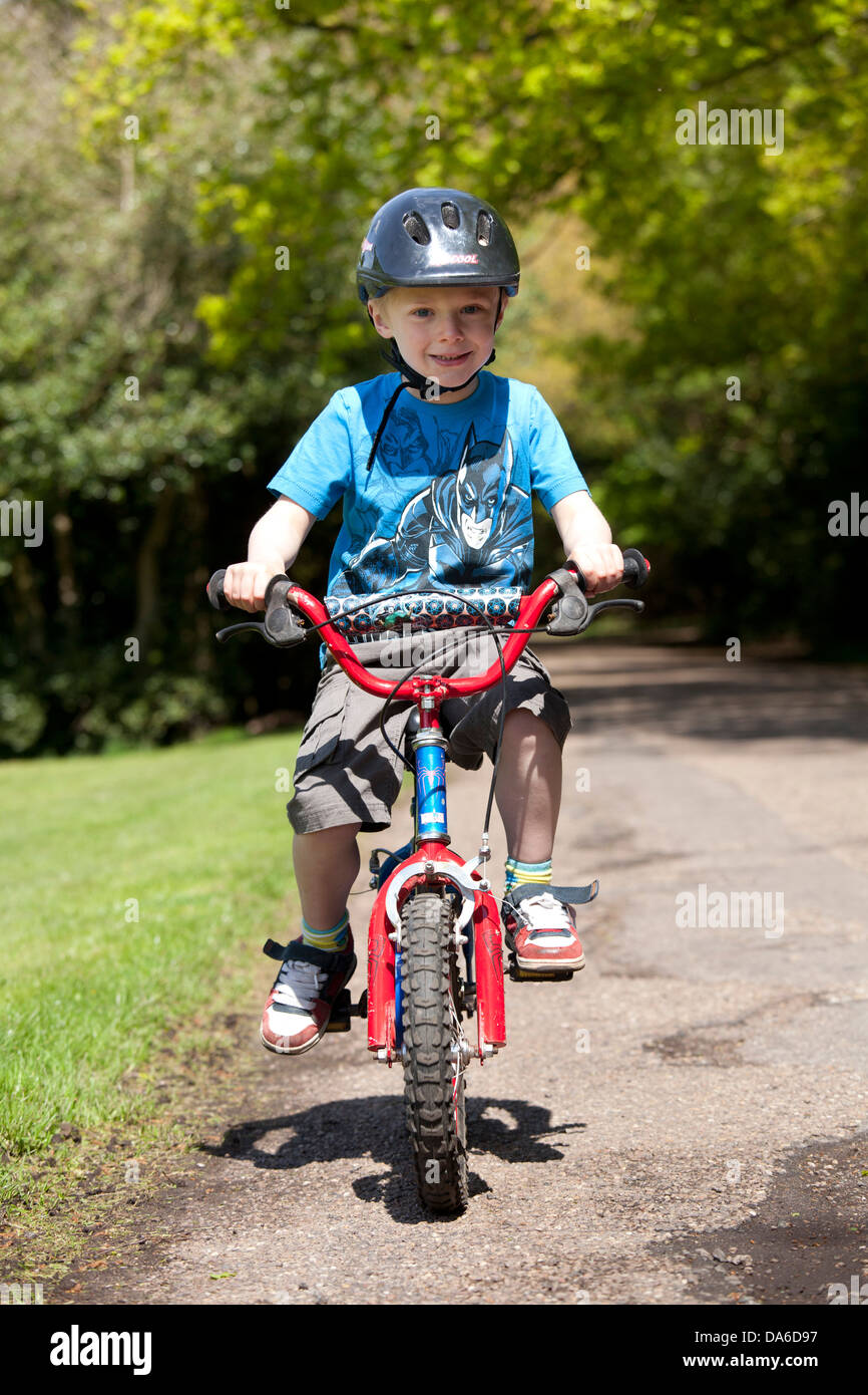 A young boy cycles through Sutton Park in the West Midlands Stock Photo ...