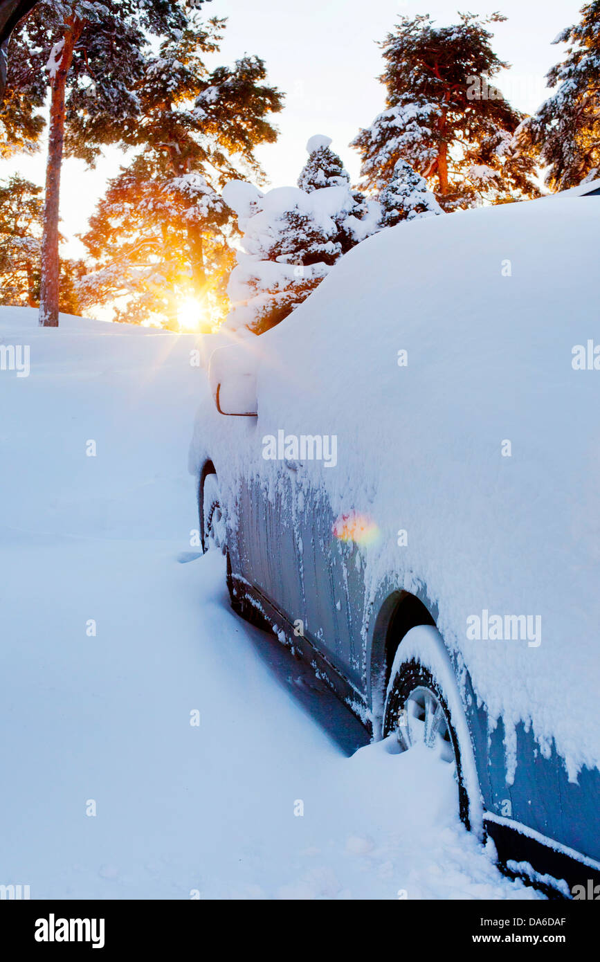 Car covered with snow at sunset Stock Photo - Alamy