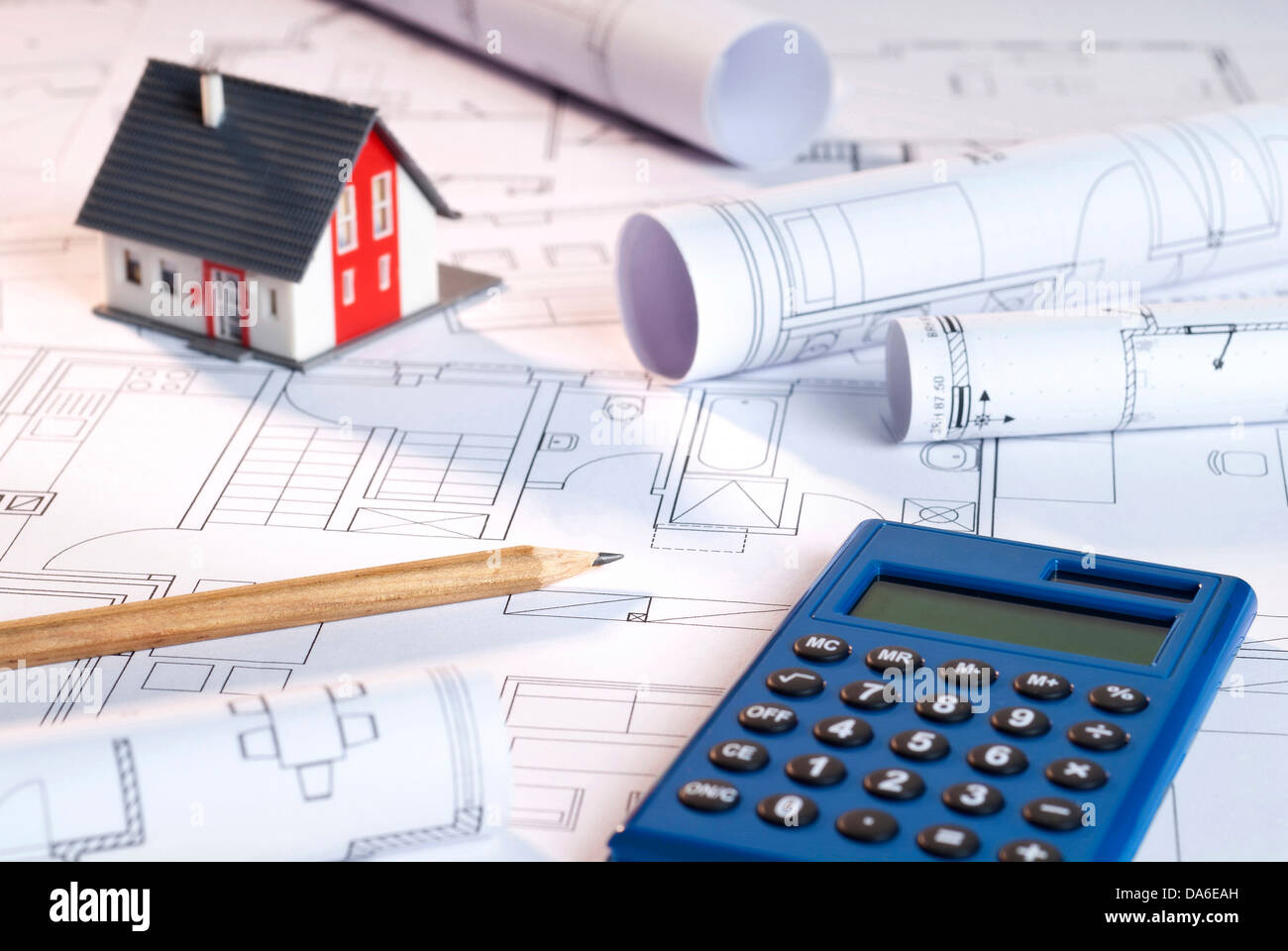 Blueprints, architectural model and calculator in the architectural ...