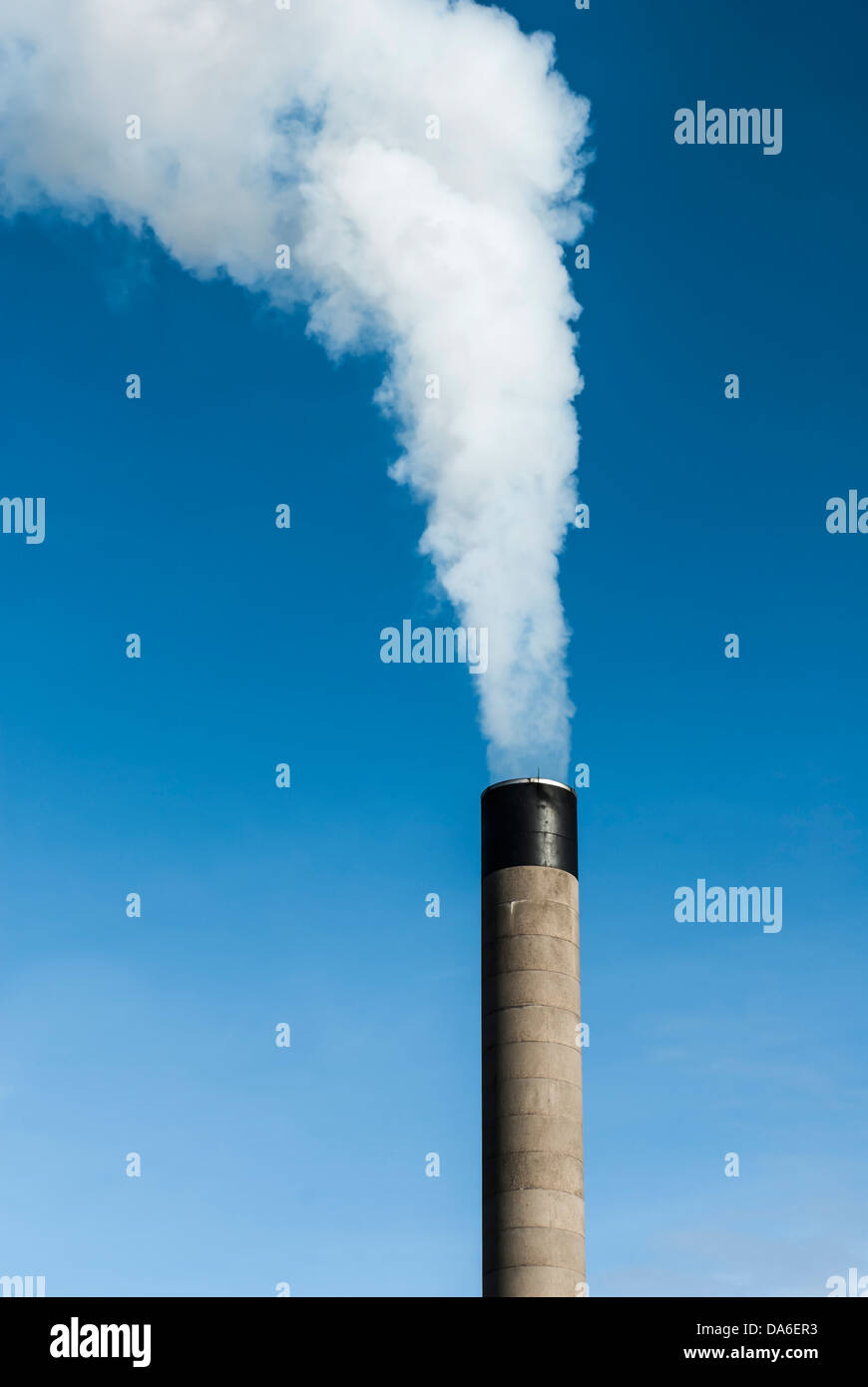 Single smoke stack against a blue sky Stock Photo - Alamy