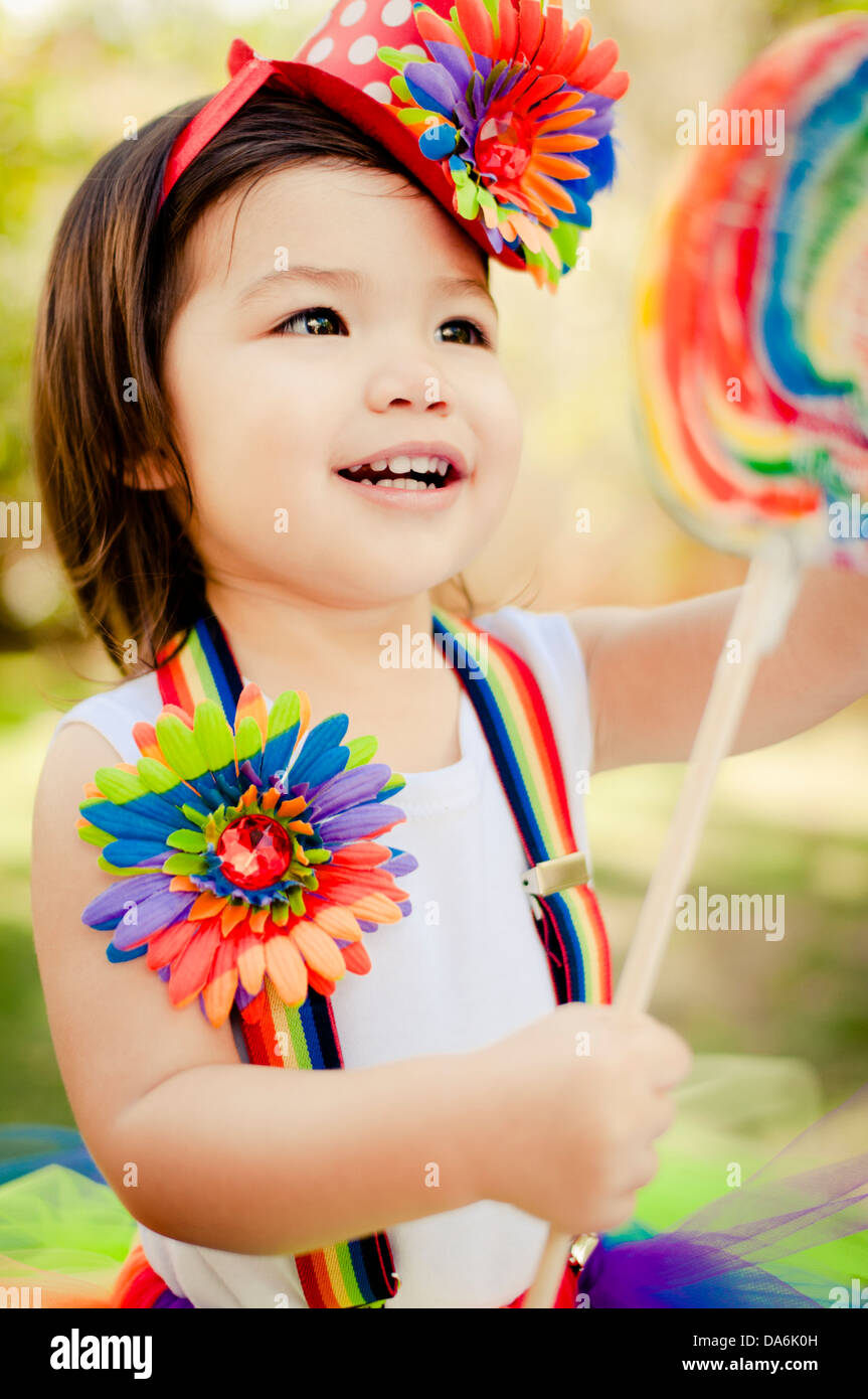 Little Asian Girl wearing a Clown Outfit and Playing with a Lolly Pop ...