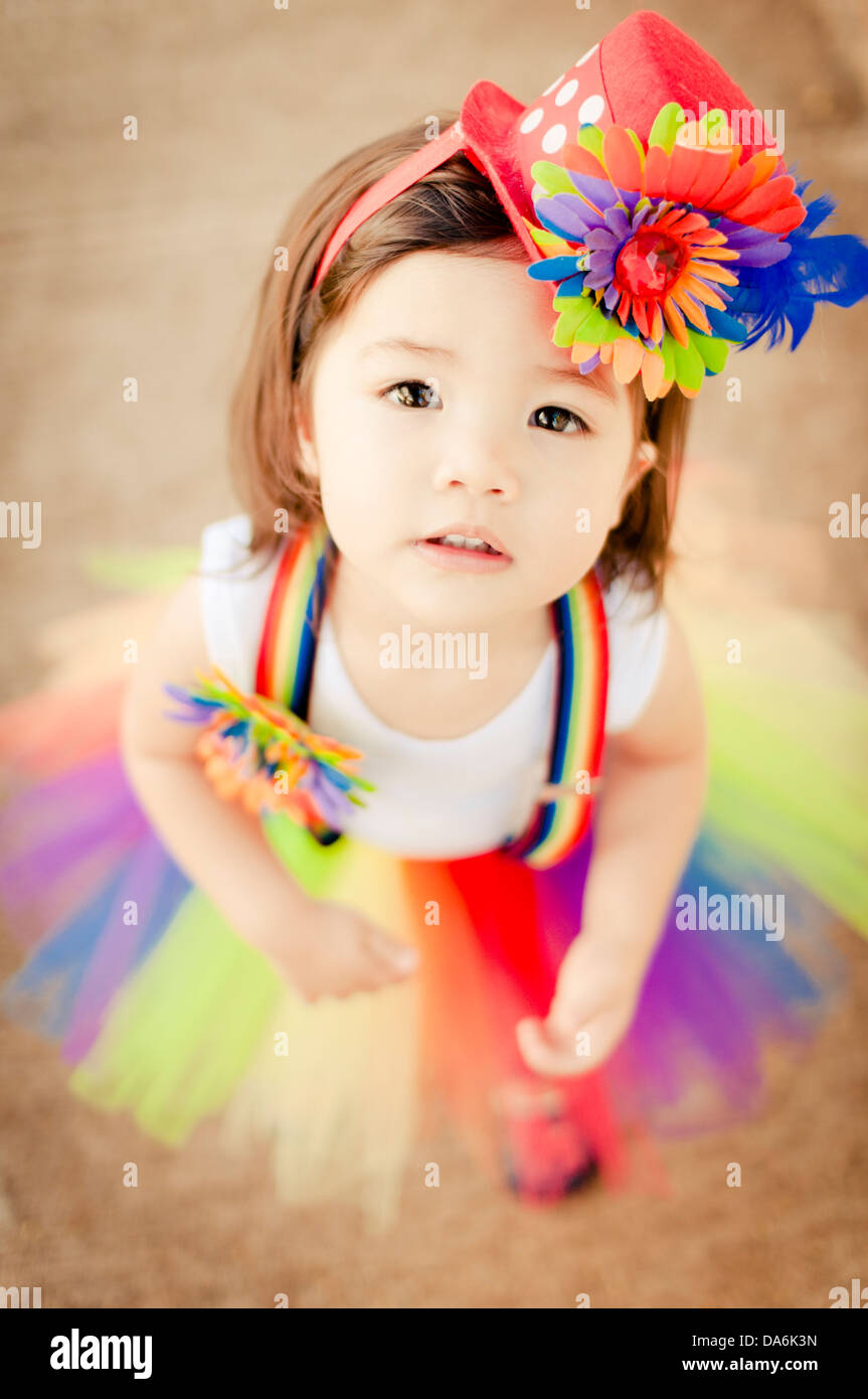 Little Asian Girl wearing a Clown Outfit and Playing with a Lolly Pop ...