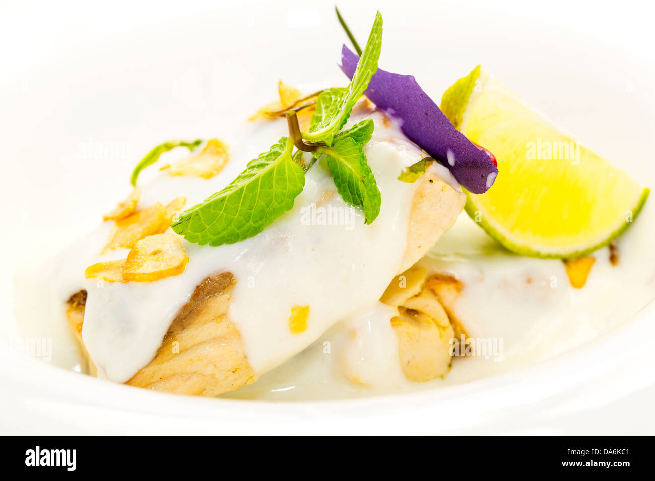 baked fish in cream sauce with lemon Stock Photo - Alamy